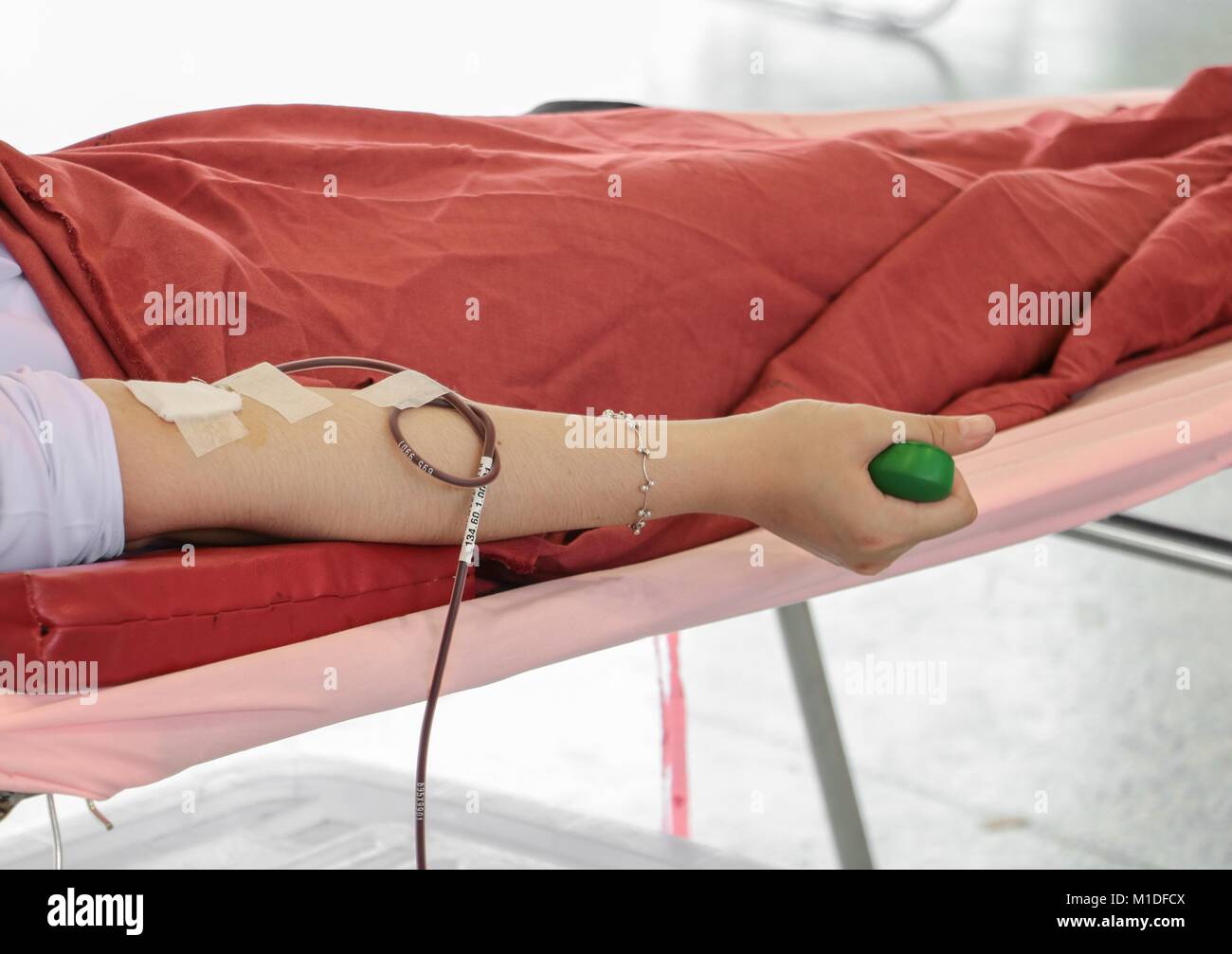 Blood donor in arm injection select focus with shallow depth of field ...