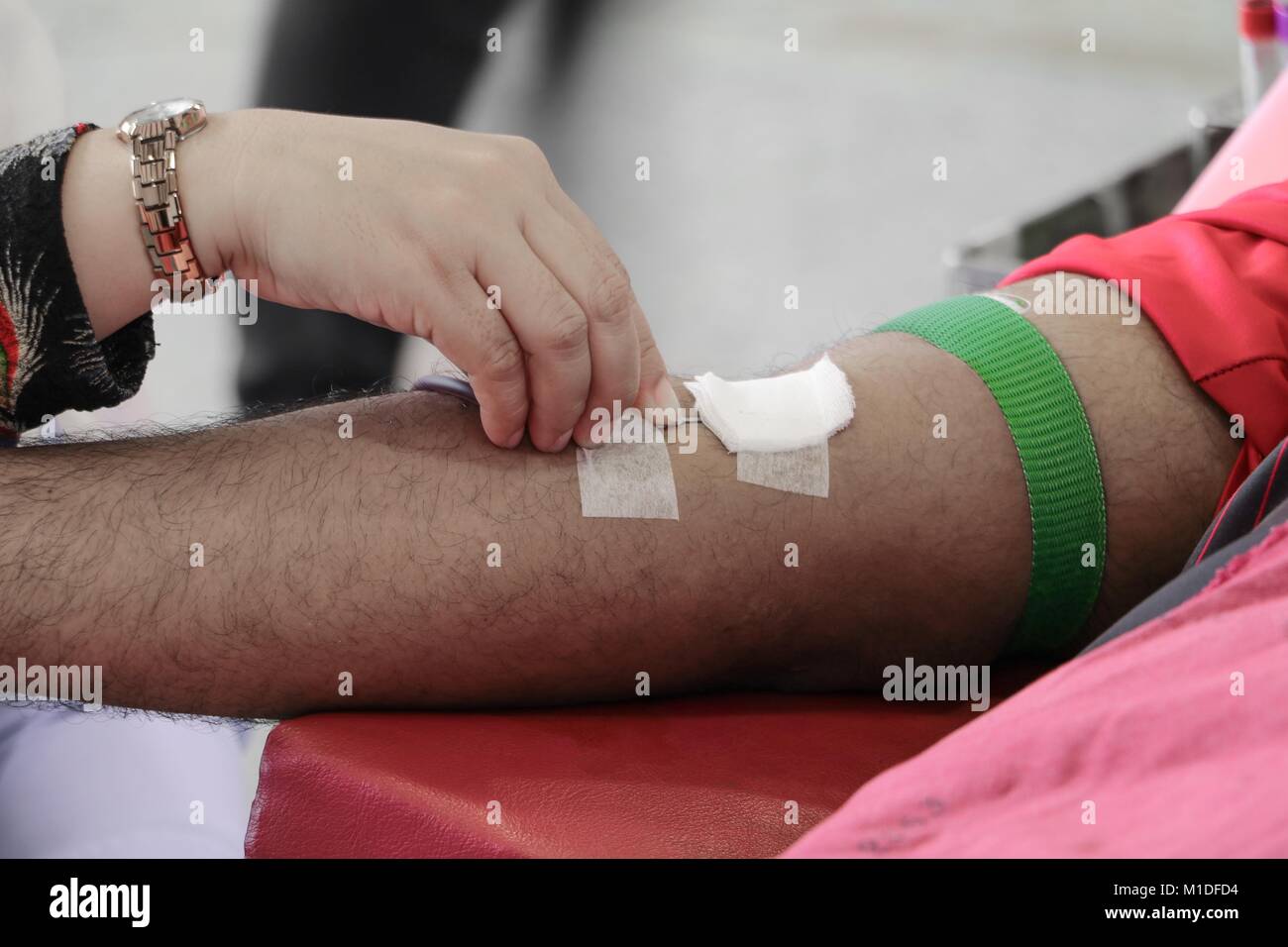 Blood donor in arm injection select focus with shallow depth of field ...