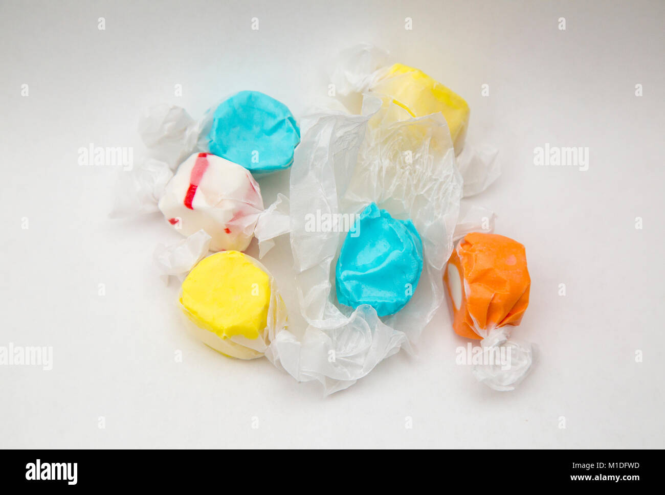 Colourful salt water taffy candy isolated Stock Photo - Alamy
