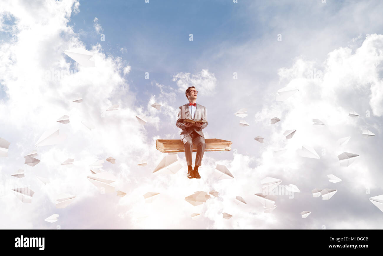 Young businessman or student in blue sky studying the science Stock ...
