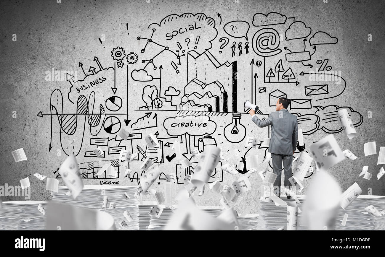 Businessman standing with megaphone Stock Photo - Alamy