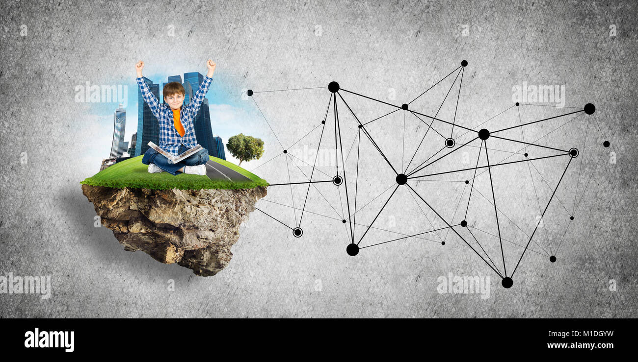 Cute boy of school age with book exploring this great world Stock Photo ...
