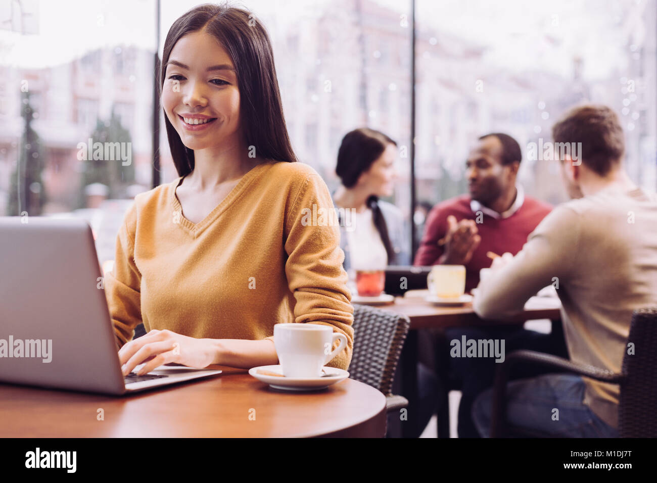 Positive cute woman searching Internet Stock Photo - Alamy