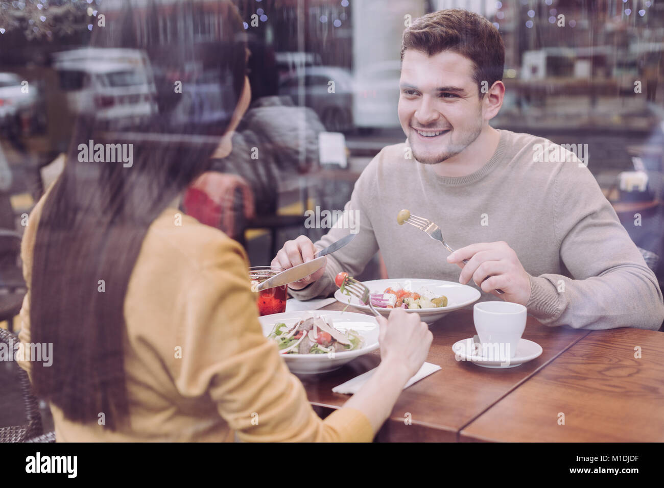 Pretty charming couple eating together Stock Photo - Alamy