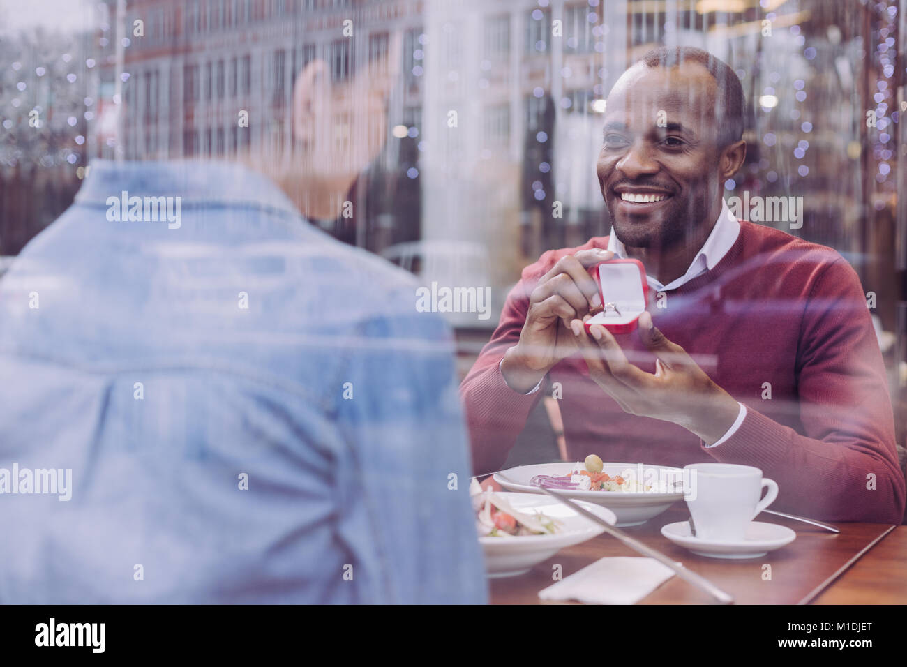 Happy enthusiastic man showing ring Stock Photo - Alamy