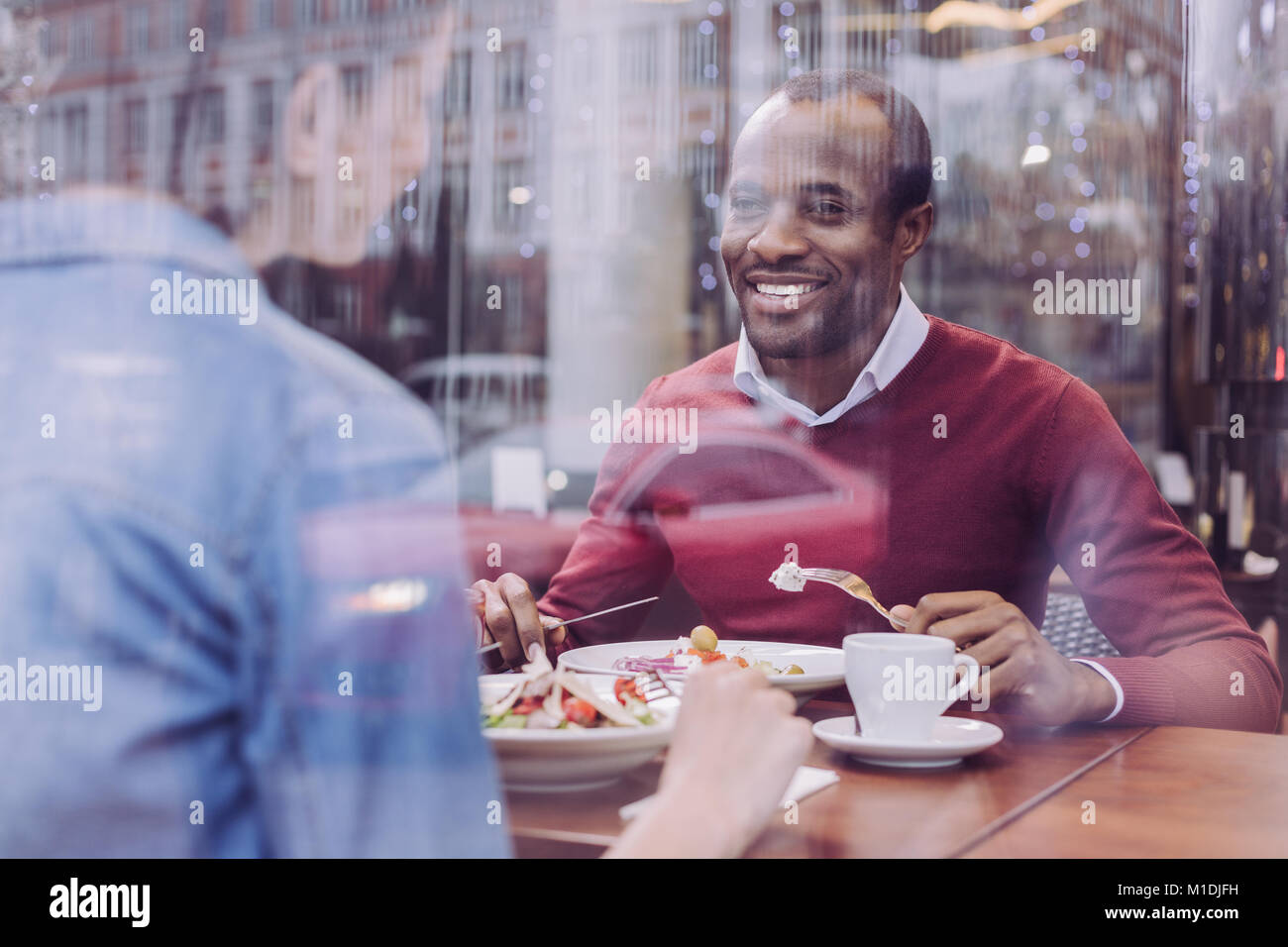 Handsome happy man eating salad Stock Photo - Alamy