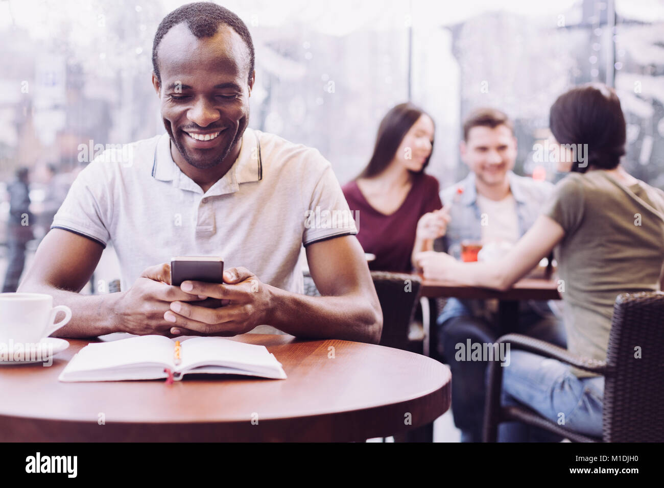 Adorable male student typing while cramming Stock Photo - Alamy