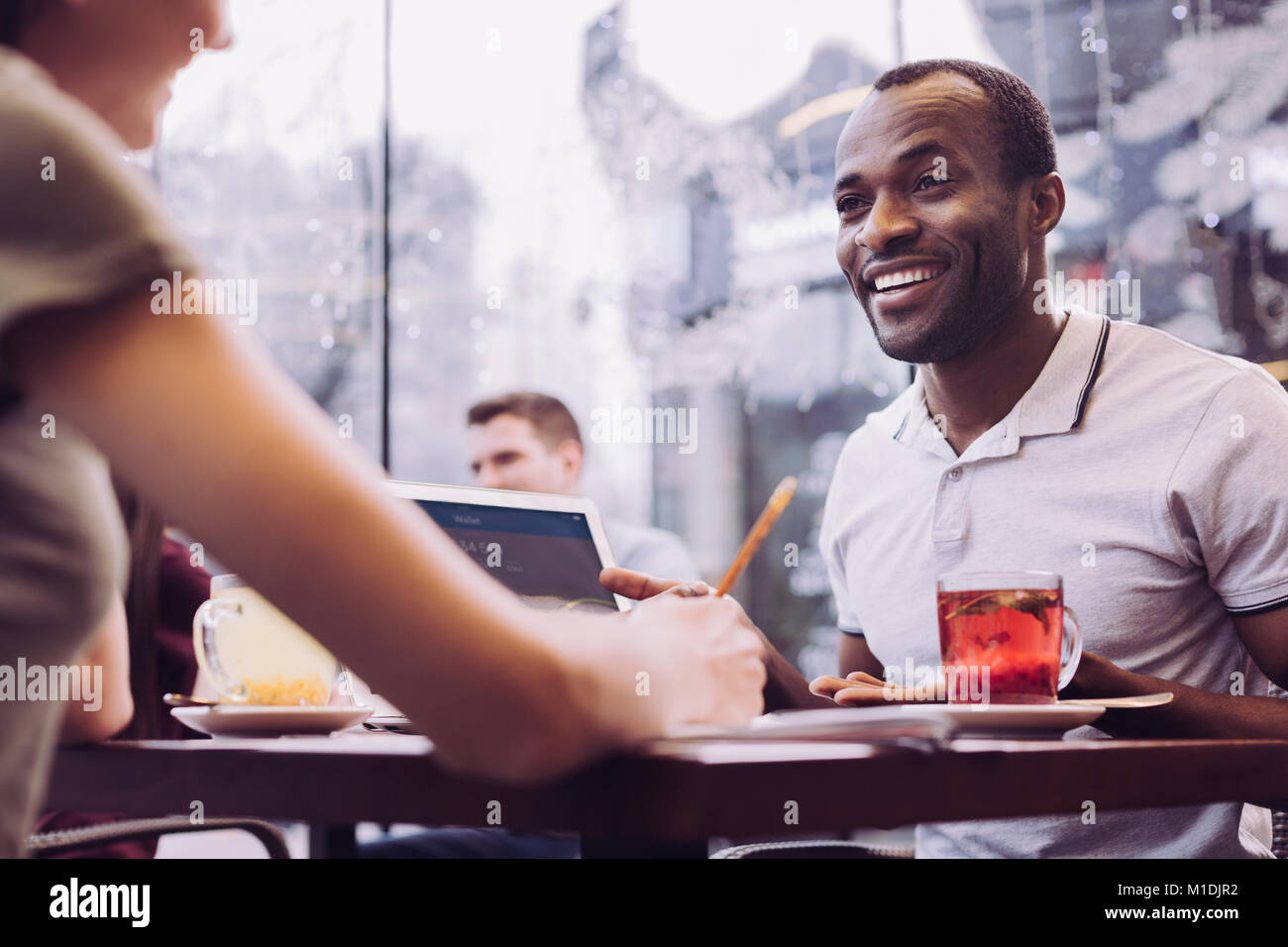 Skillful two colleagues working at cafe Stock Photo - Alamy