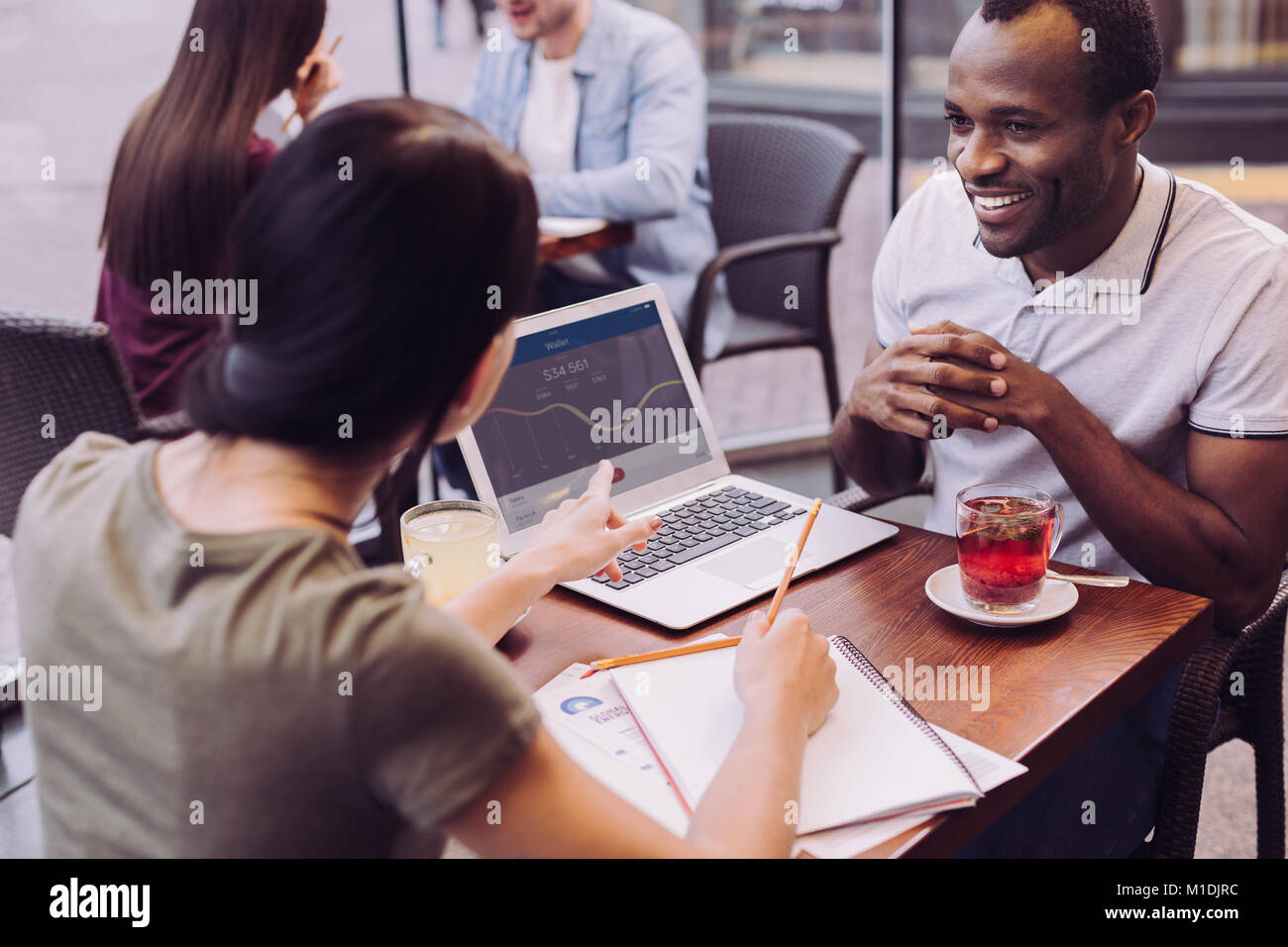 Optimistic two colleagues developing plan Stock Photo - Alamy