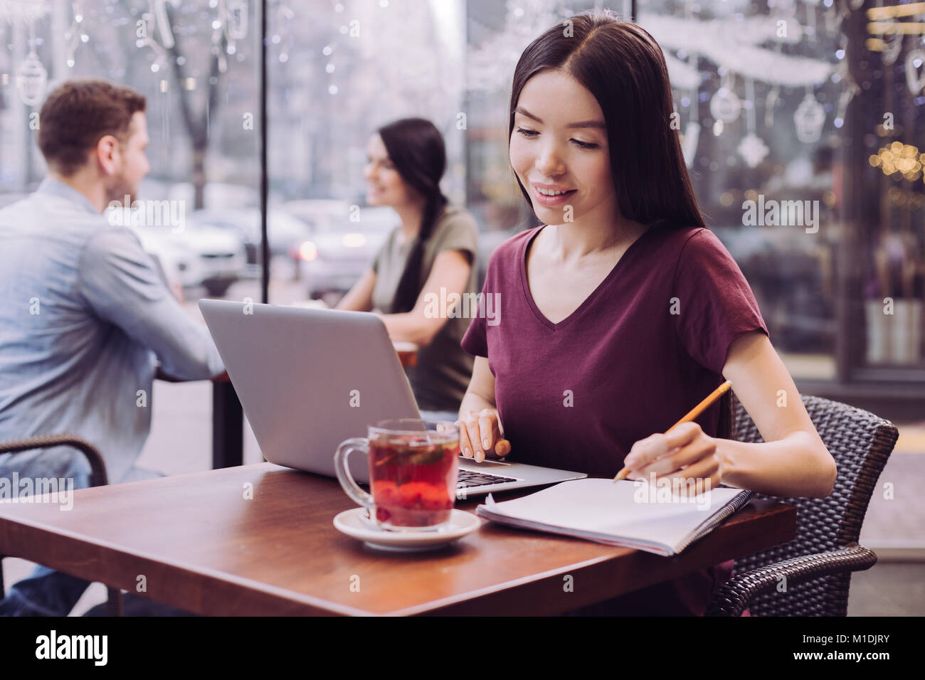 Diligent female student noting quotations Stock Photo - Alamy