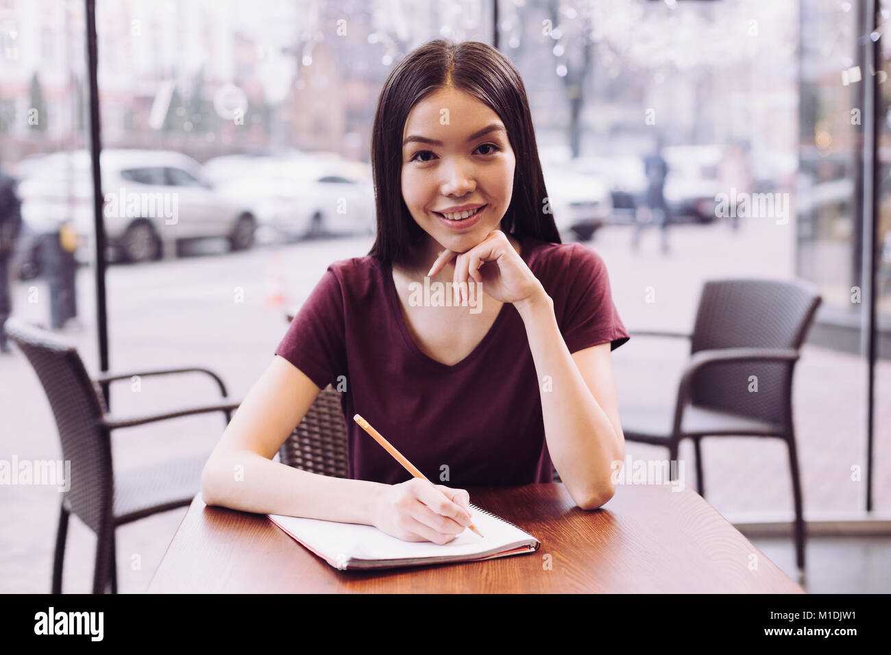 Brunette female student working on task Stock Photo - Alamy