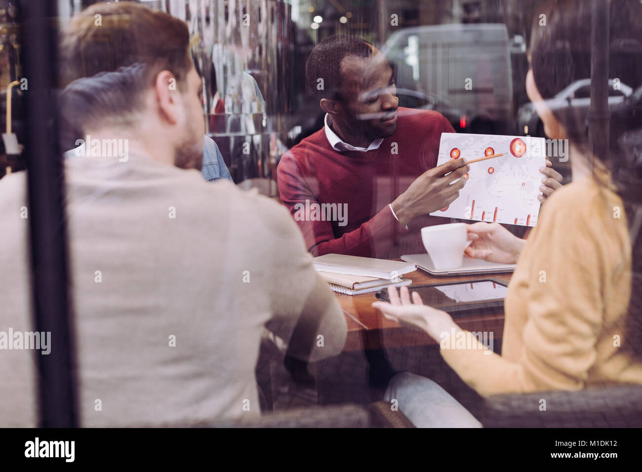 Ambitious three colleagues observing diagram Stock Photo - Alamy