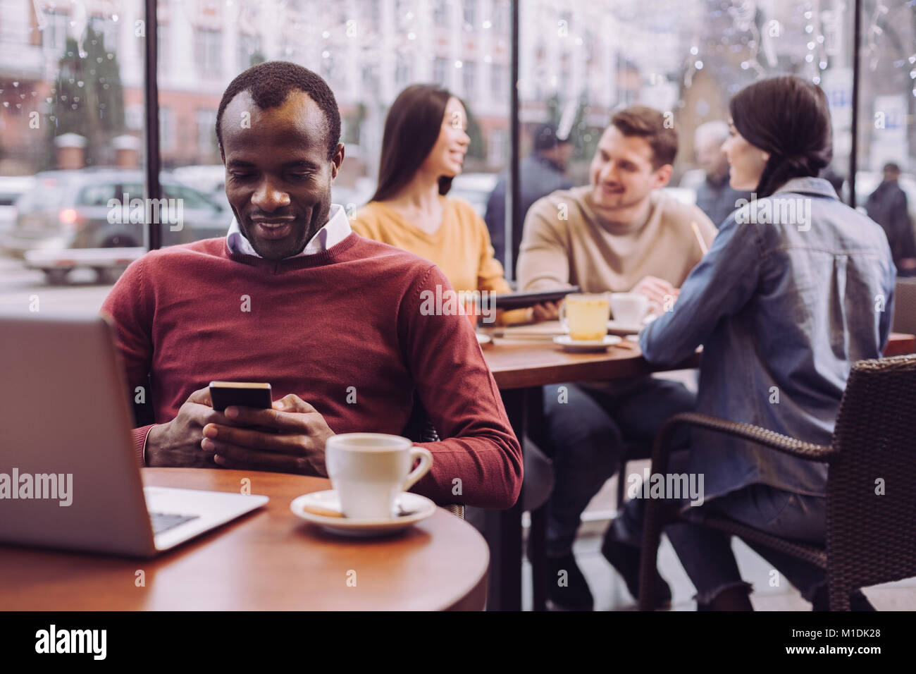 Relaxed calm man reviewing photos on phone Stock Photo - Alamy