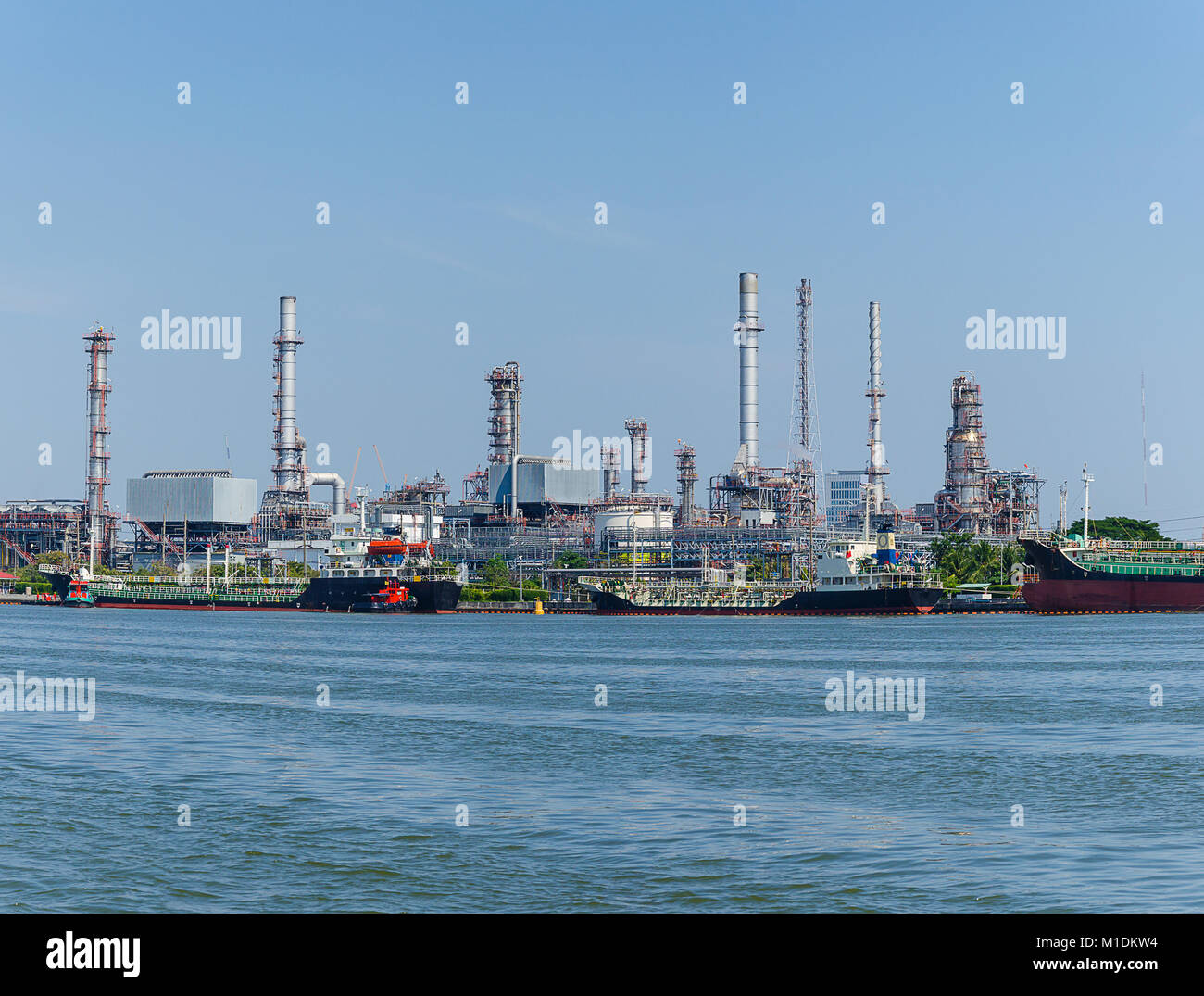 Boats in the harbor Oil Refinery Stock Photo - Alamy