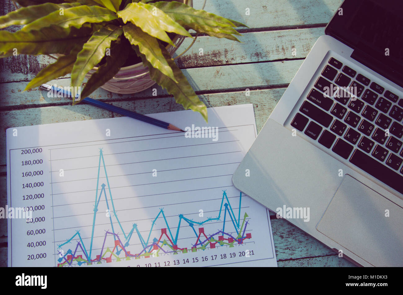 Laptops and graphs with a pencil on a wood table. Tone vintage Stock ...