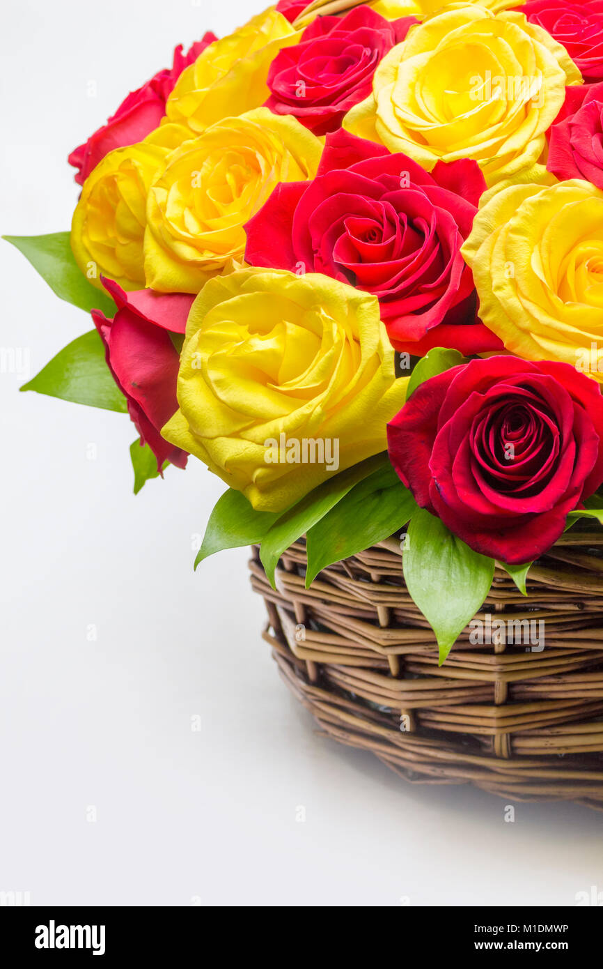 Part of a bouquet of red and yellow roses in a basket close-up Stock ...