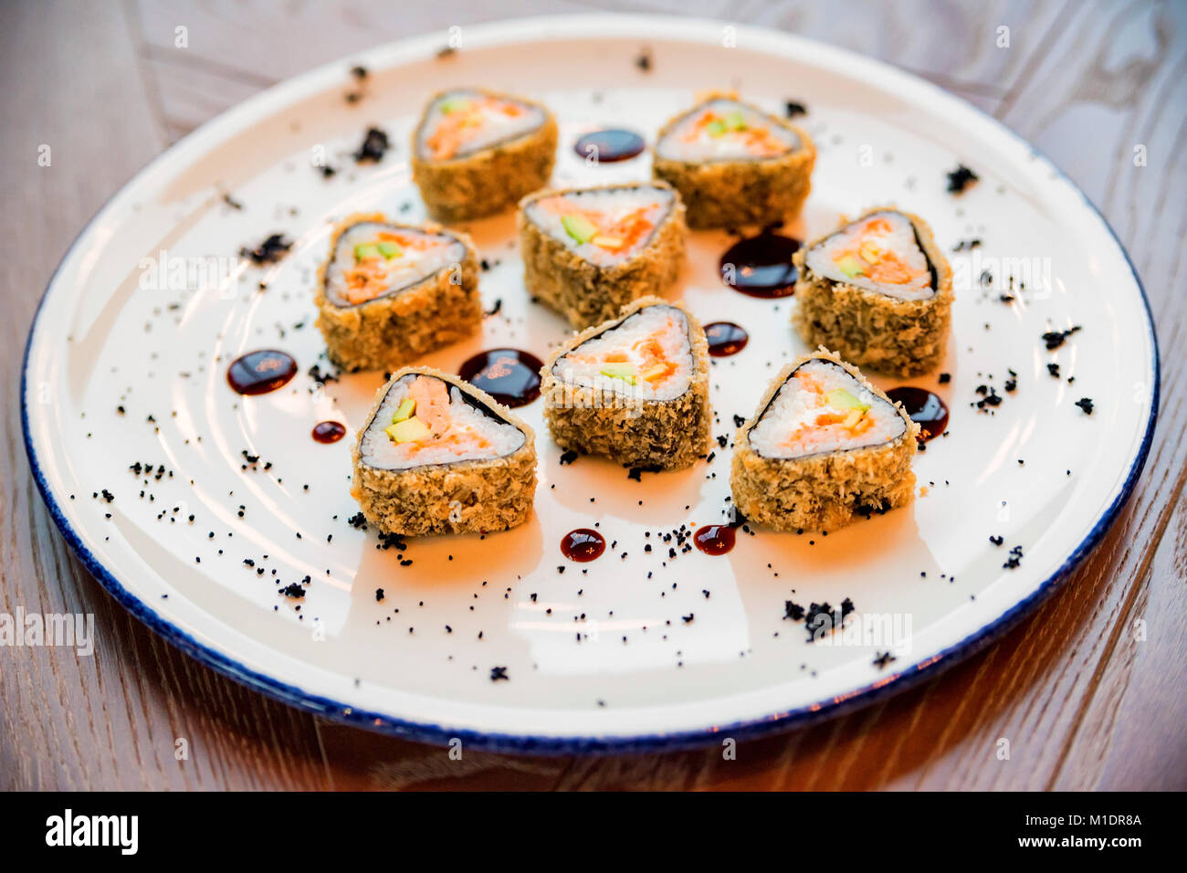 Close up delicious triangle sushi rolls on plate Stock Photo - Alamy