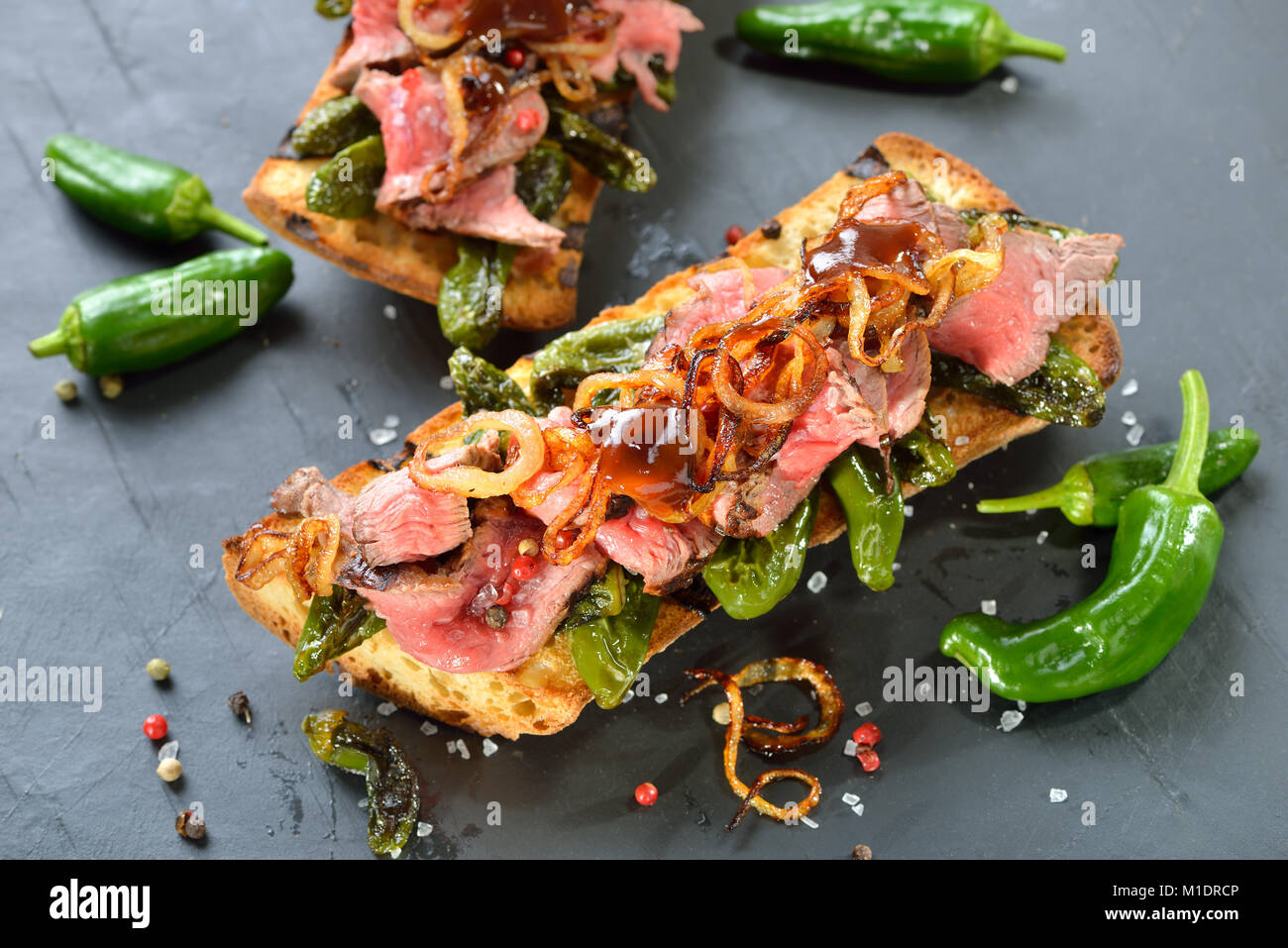 Street food: Hot Panini topped with fried pimentos, grilled beef steak ...