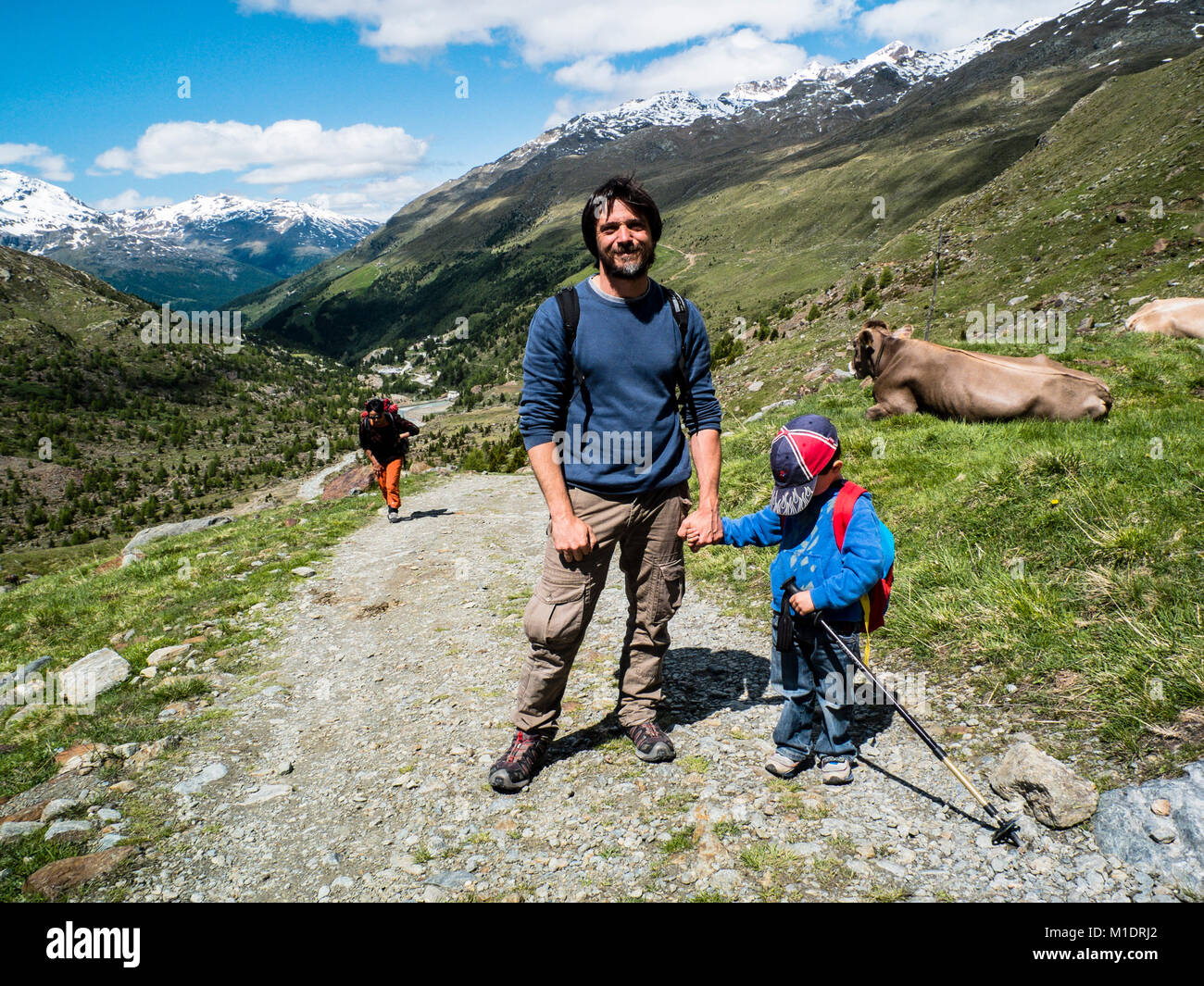 Italian Alps in Lombardy, Bormio, father holds his son by the hand ...