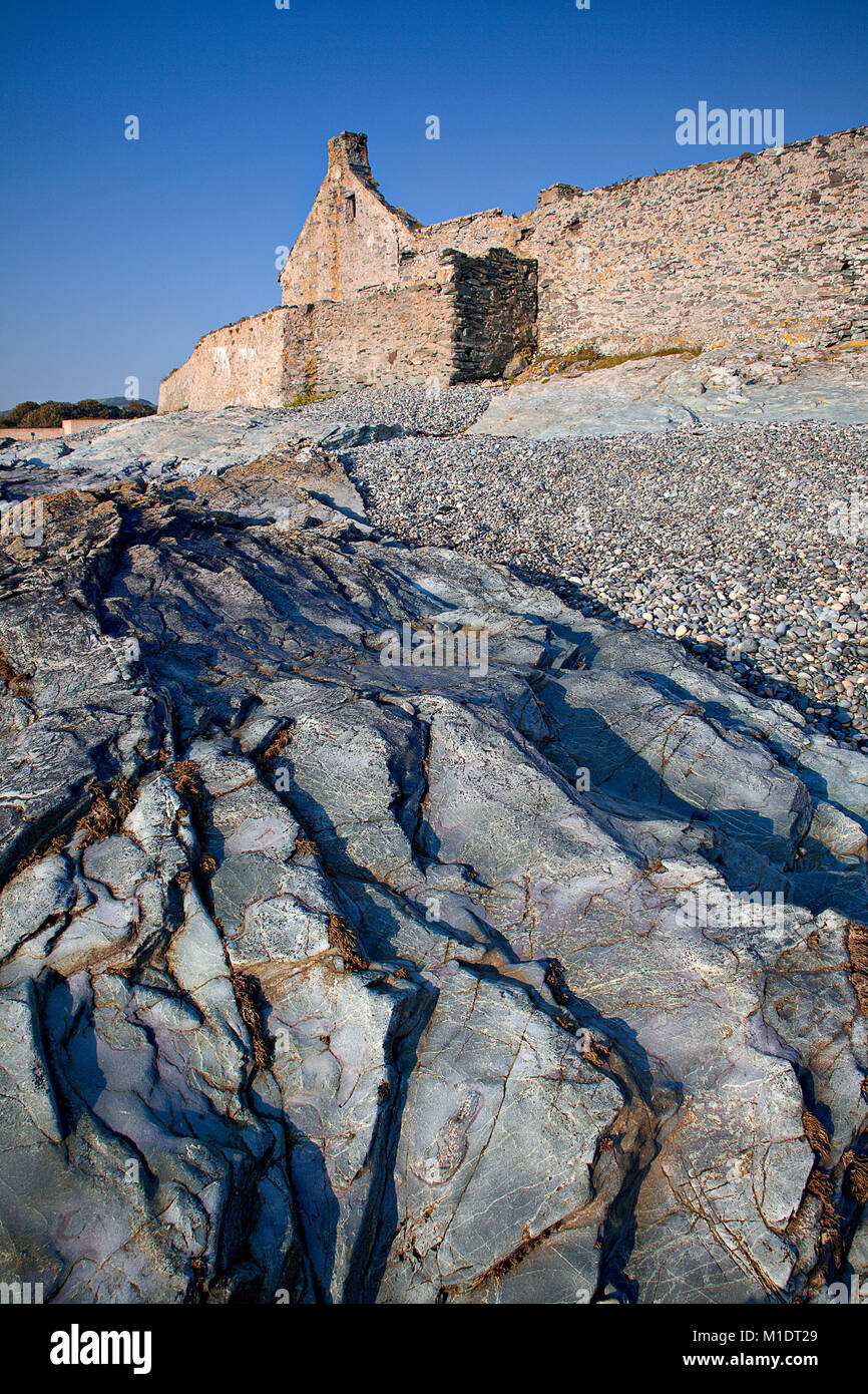 Old cottage and rocks on the coast at Cemlyn, Anglesey, North Wales ...