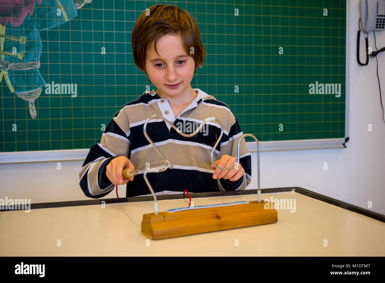 A boy conducts an electricity experiment with a rod Stock Photo - Alamy