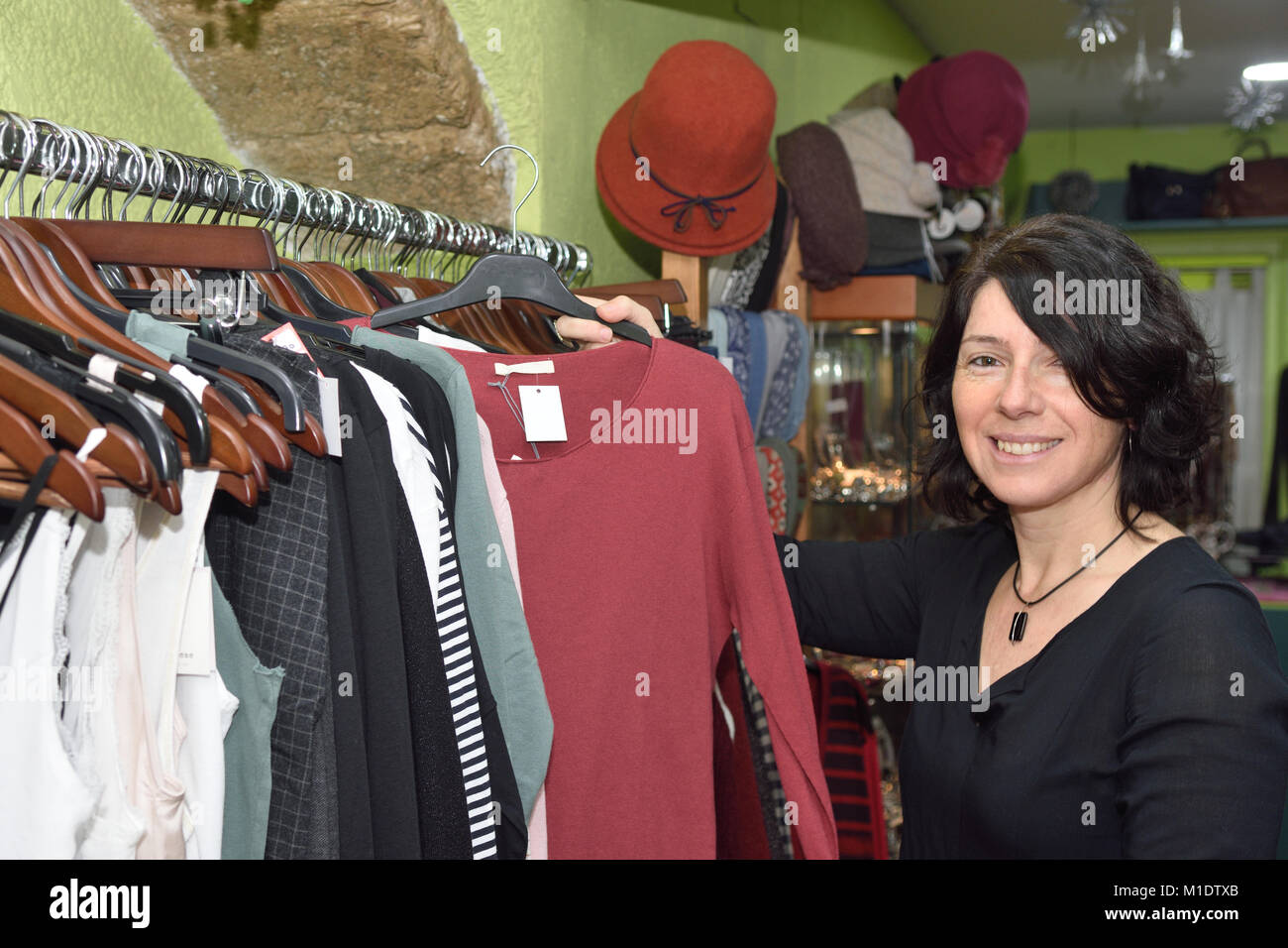 Woman buying clothes in a bazaar Stock Photo - Alamy