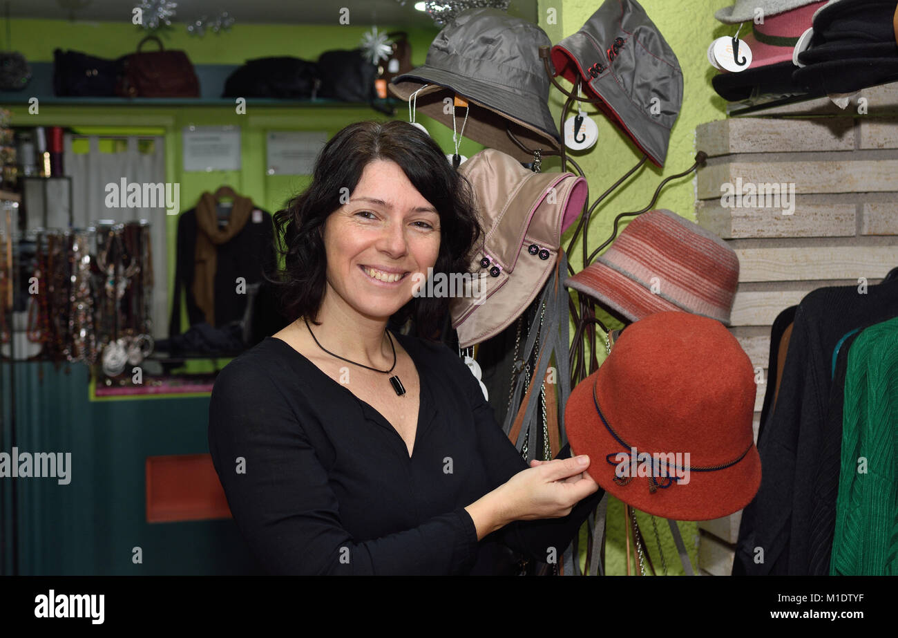 woman buying a hat in clothing market Stock Photo - Alamy