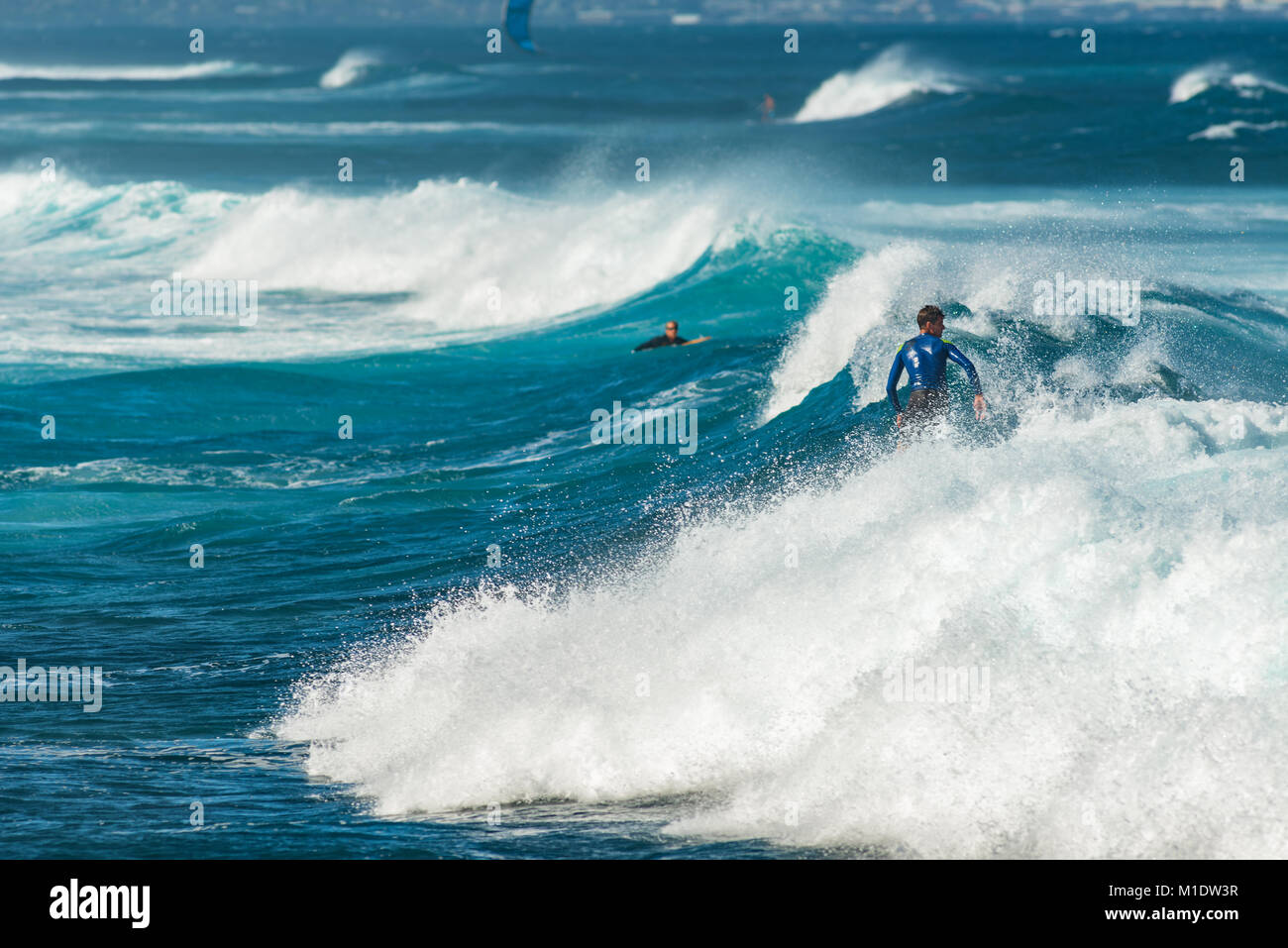 MAUI, HAWAII, USA - DECEMBER 10, 2013: Surfers are riding waves at ...