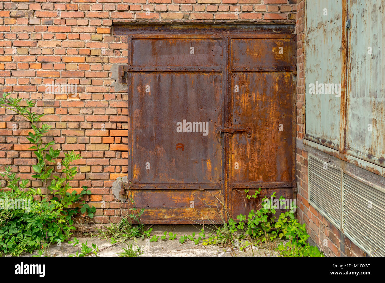 Old rusted big iron door of a building Stock Photo - Alamy