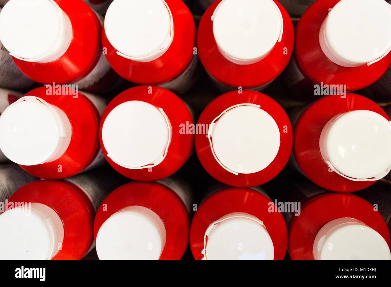 Packings of ketchup stand on the table symmetrically with lids up ...