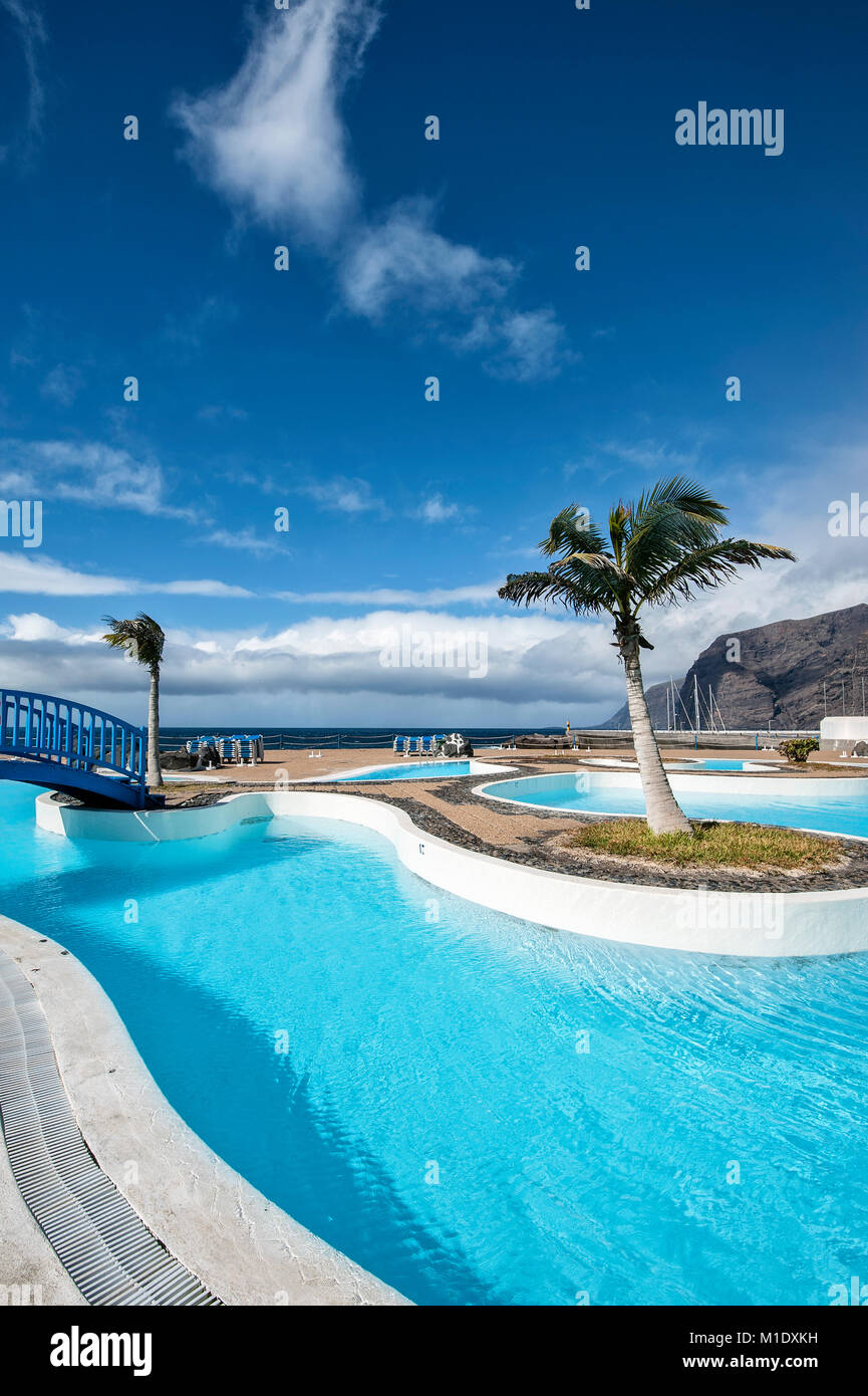 Swimming pool at the port of Los Gigantes with Masca Mountains in the ...