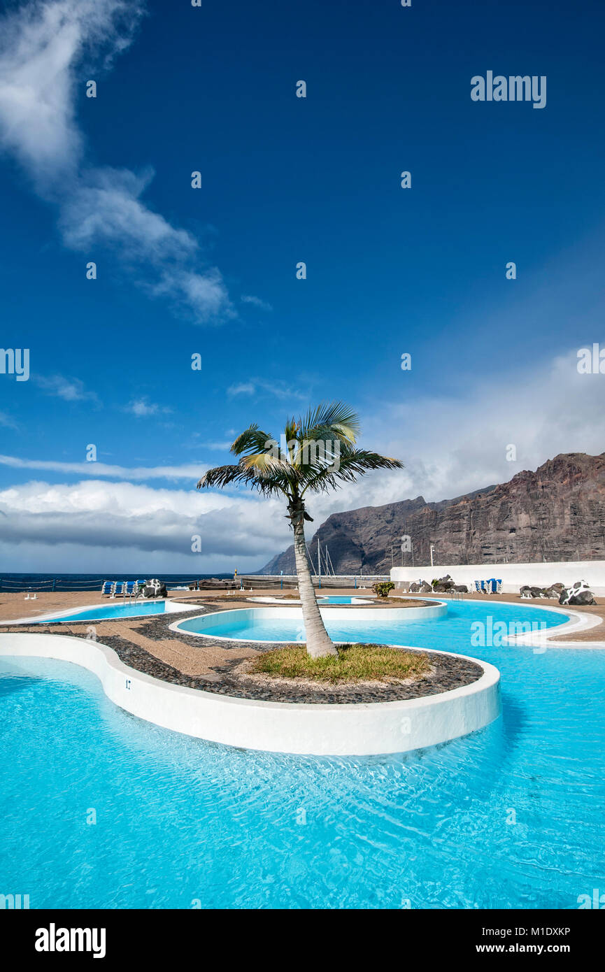 Swimming pool at the port of Los Gigantes with Masca Mountains in the ...
