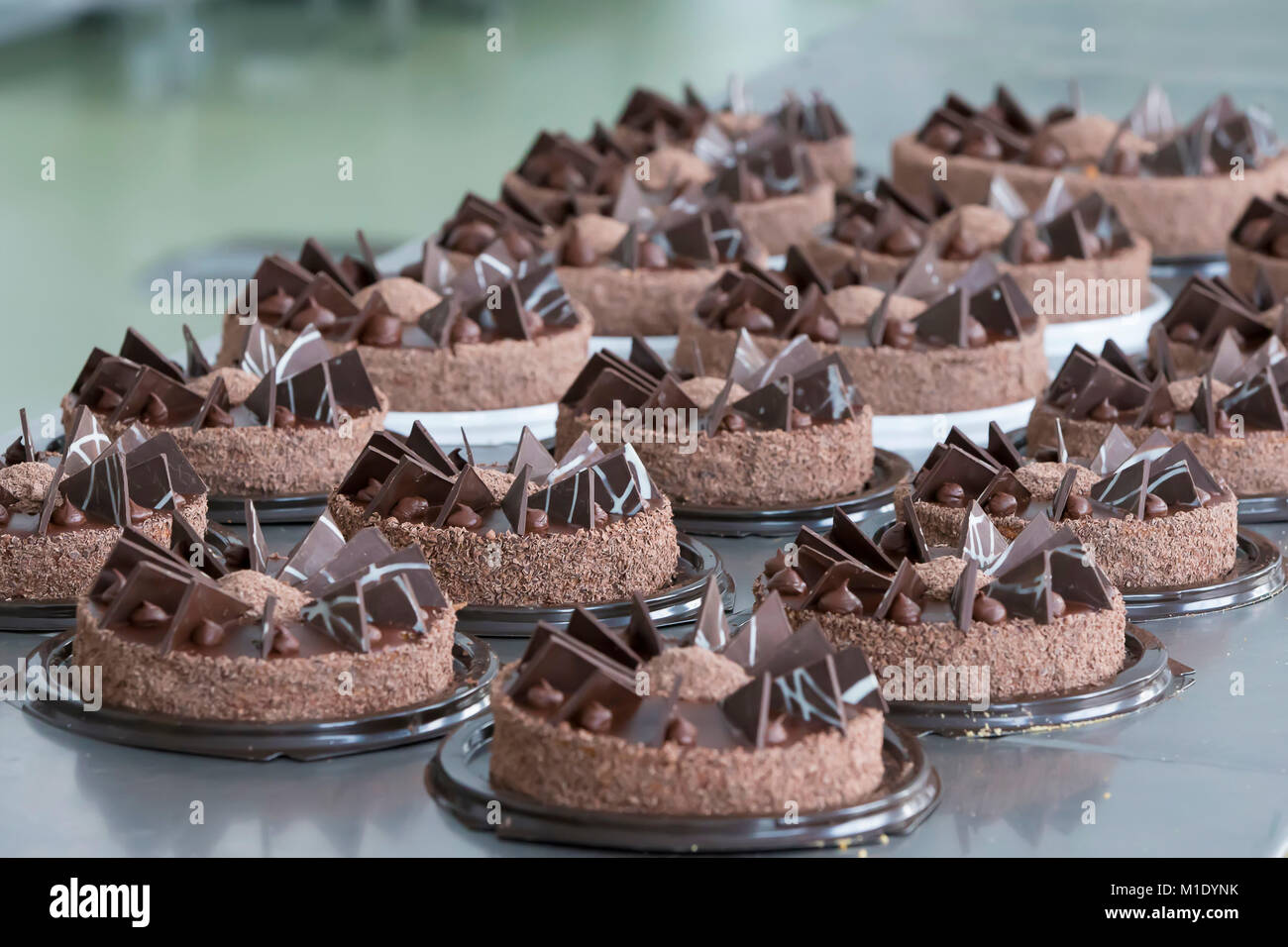 Industrial line of cakes. Many beautiful cakes on the table Stock Photo ...