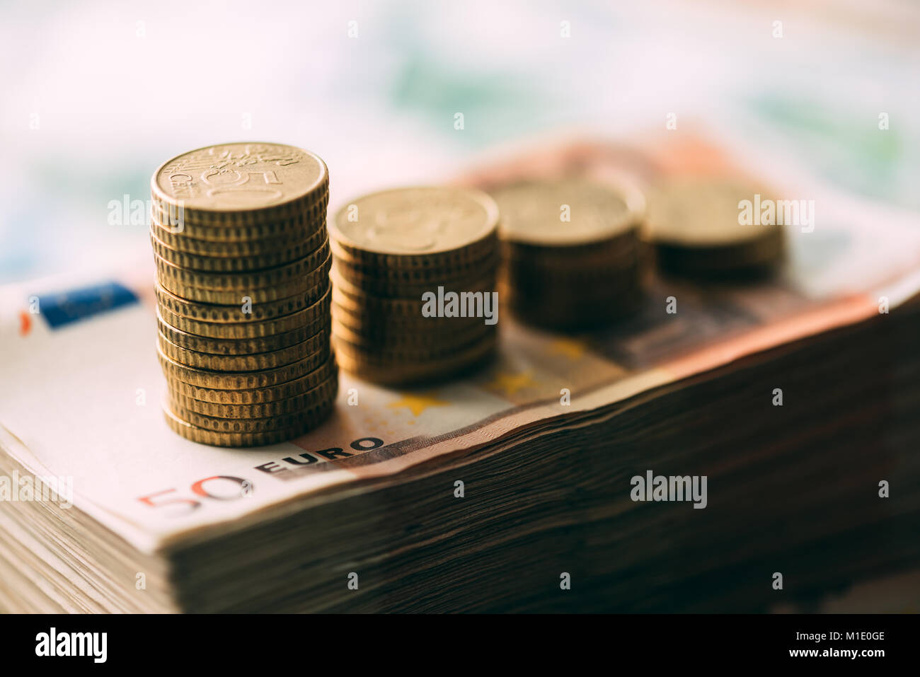 Euro coins on cash stack closeup Stock Photo - Alamy