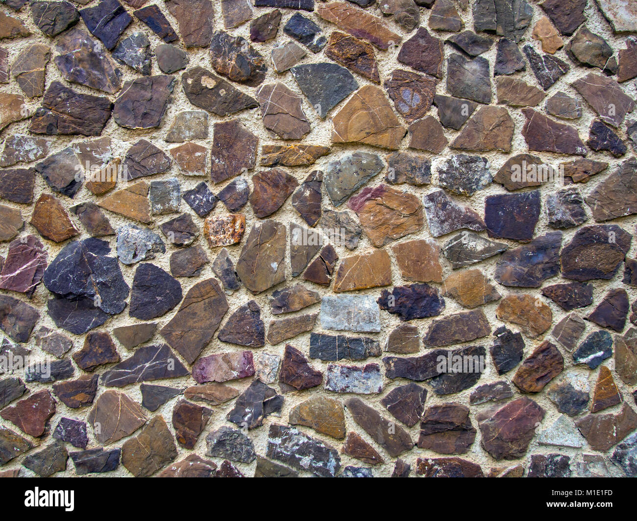 Mosaic wall lined with multi-colored natural stones Stock Photo - Alamy