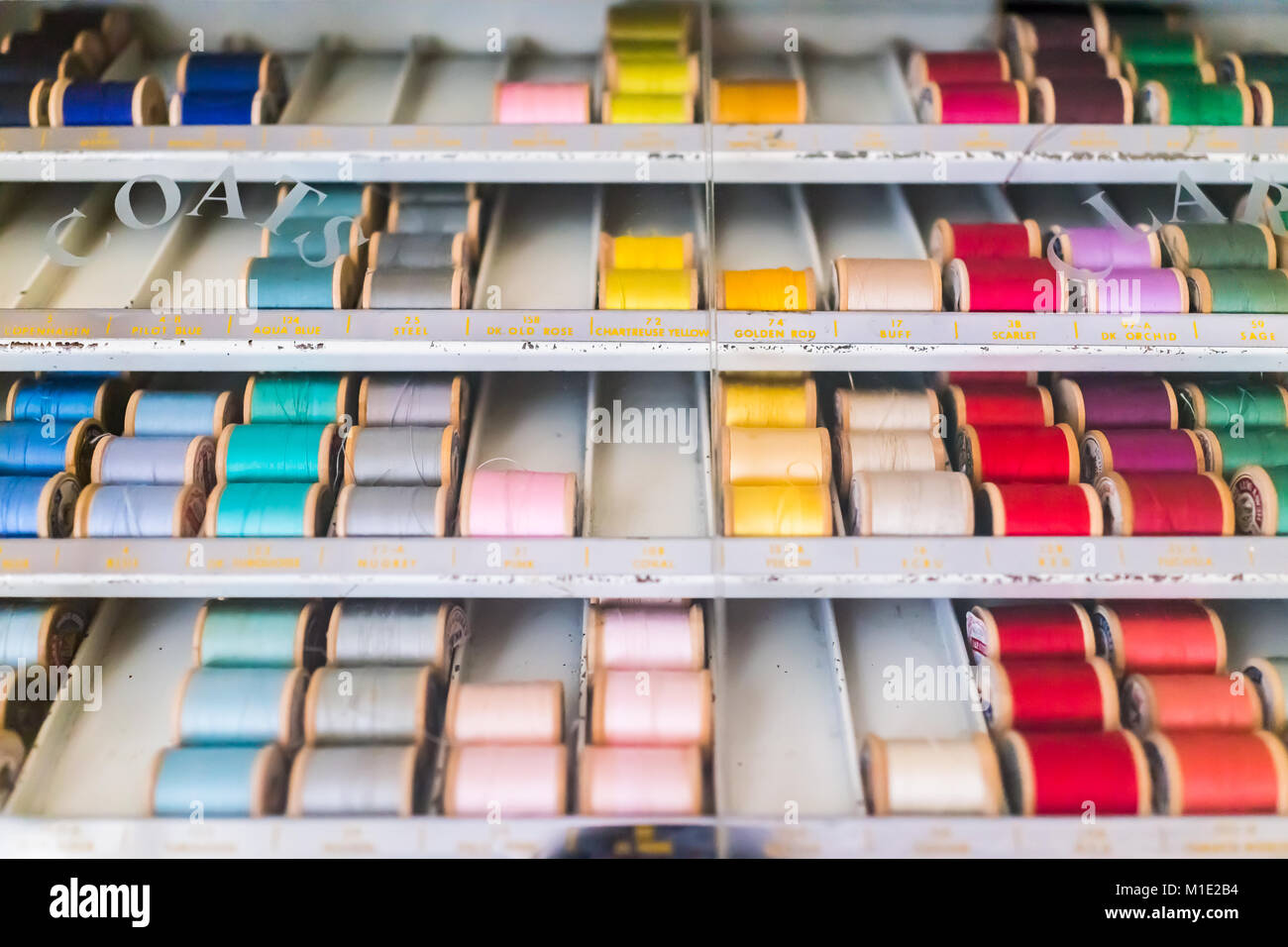 Colorful threads on spools closeup, sewing strings collection with many ...