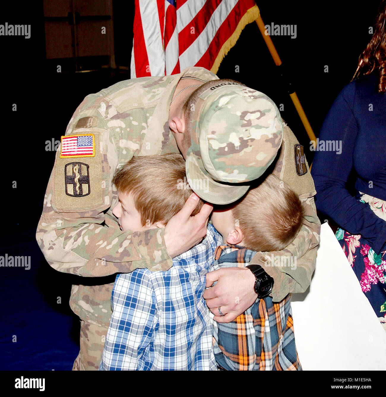 Staff Sgt. Joseph Clifford hugs his sons, James, 8, and Samuel 7 Stock ...