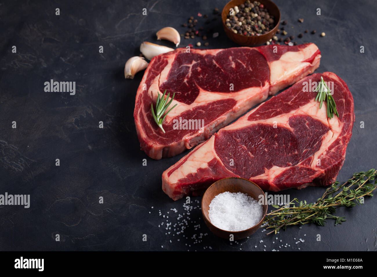 Raw fresh marbled meat Steak Ribeye Black Angus on black marble ...