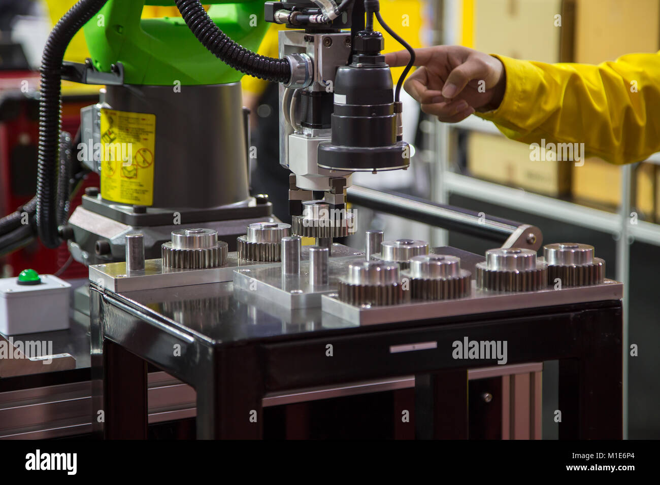 Worker operating 2D sensor robotic assembly machine Stock Photo - Alamy
