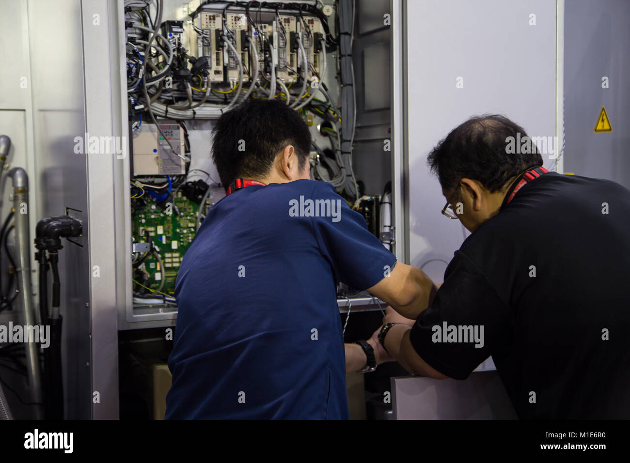 Technician repair and maintenance CNC machine Stock Photo - Alamy