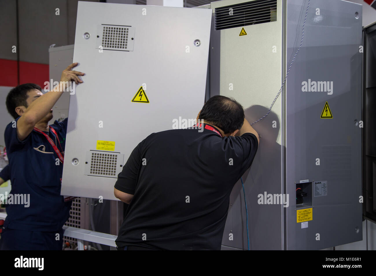 Technician repair and maintenance CNC machine Stock Photo - Alamy