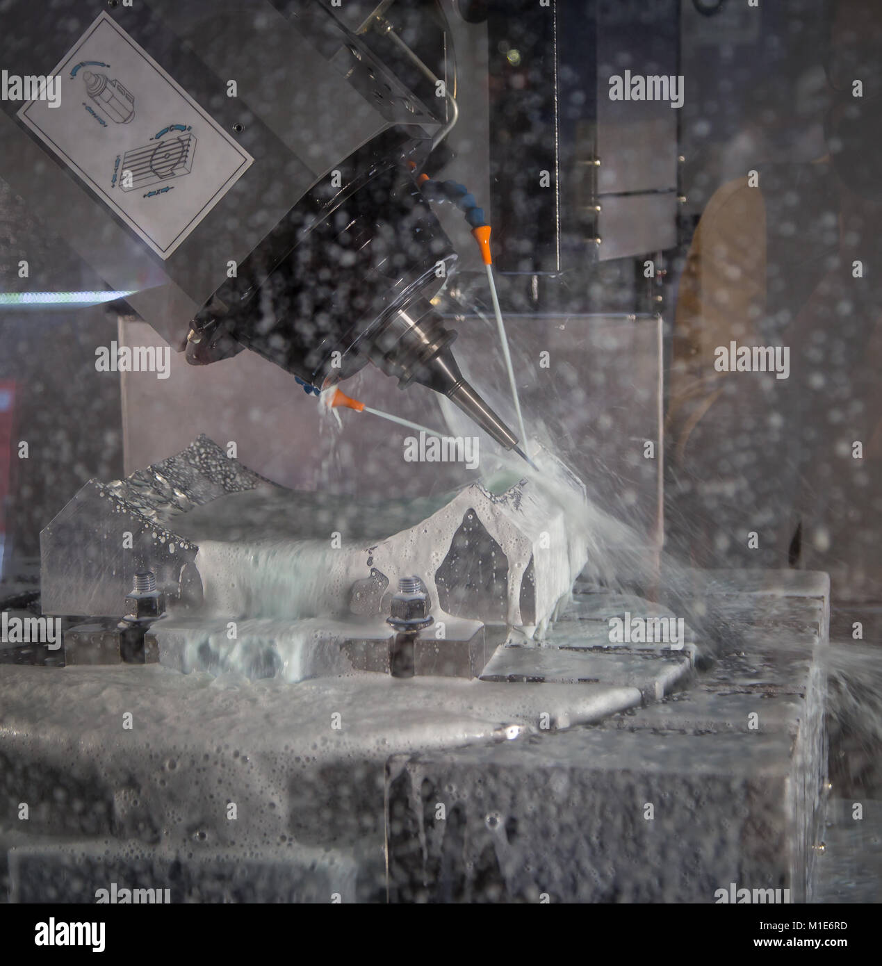CNC milling machine milling workpiece with coolant Stock Photo - Alamy