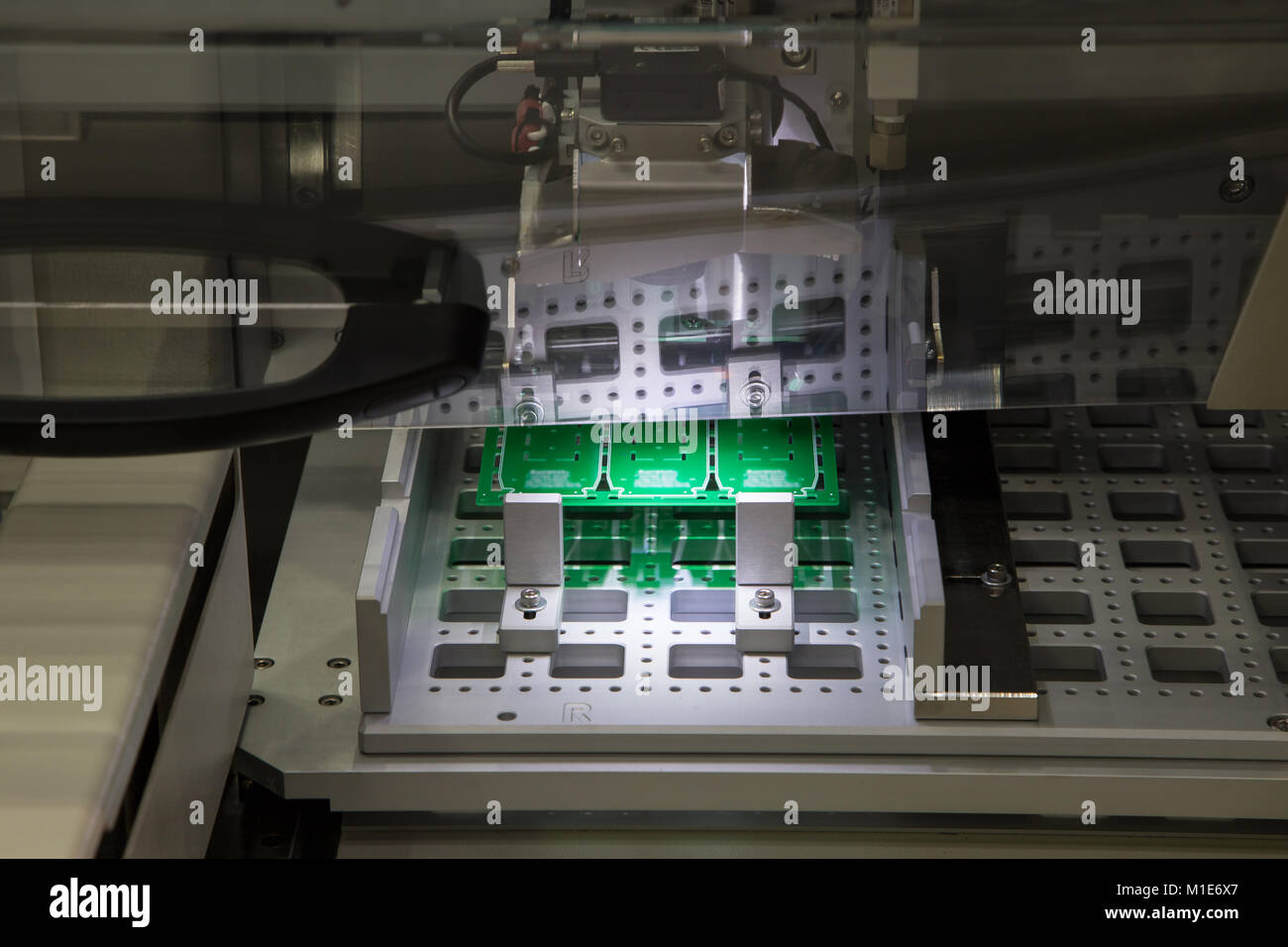 PCB loading / unloading for in-line PCB router Stock Photo - Alamy