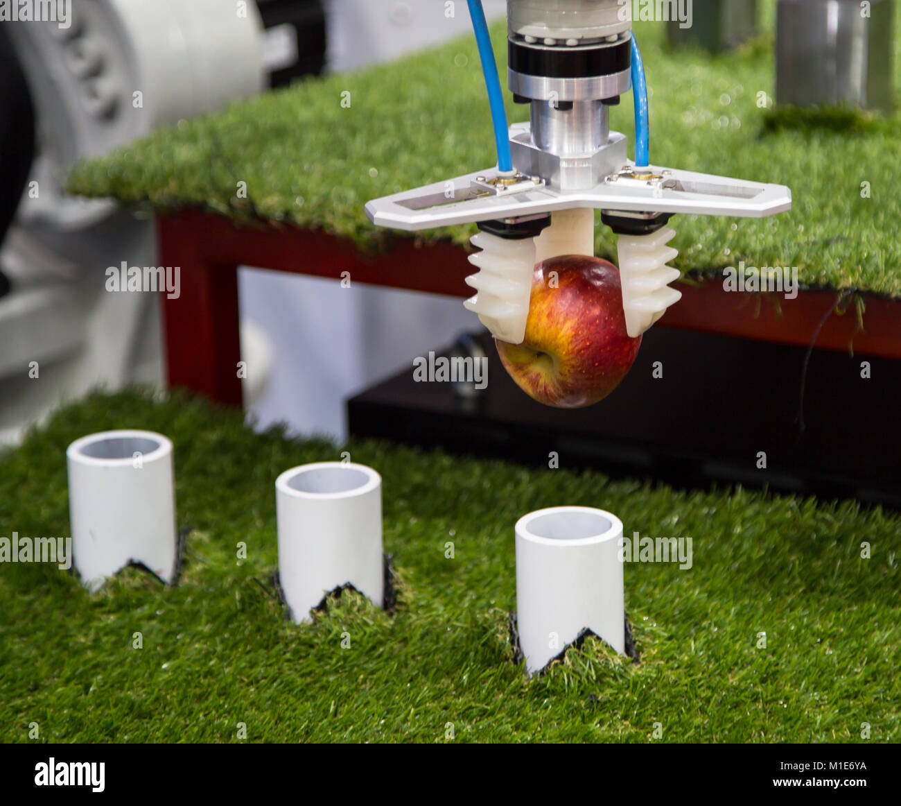 Robotic arm demonstration lifting apple and put on pipe Stock Photo - Alamy
