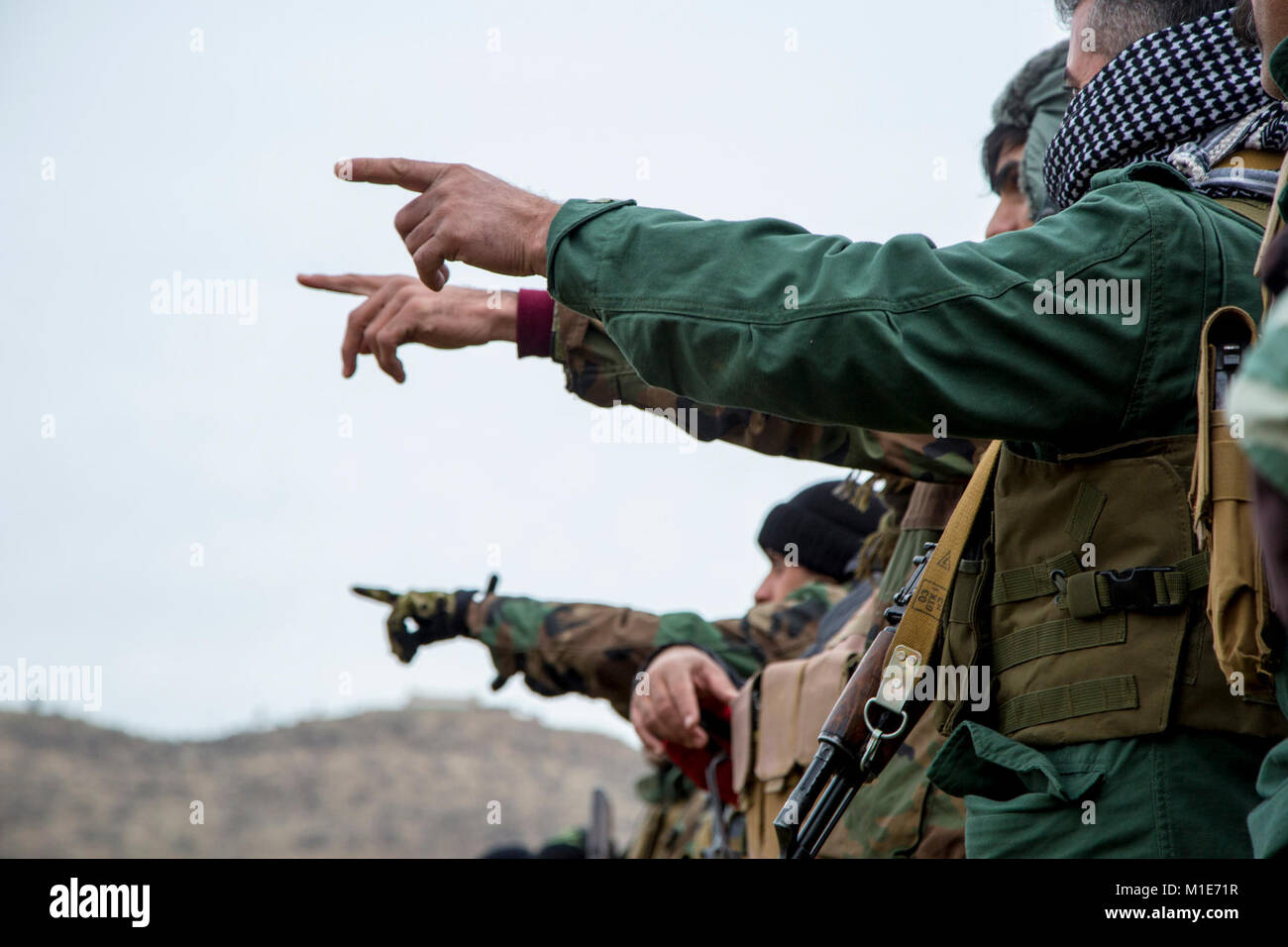 Coalition Partners And Security Force Members Point Towards The
