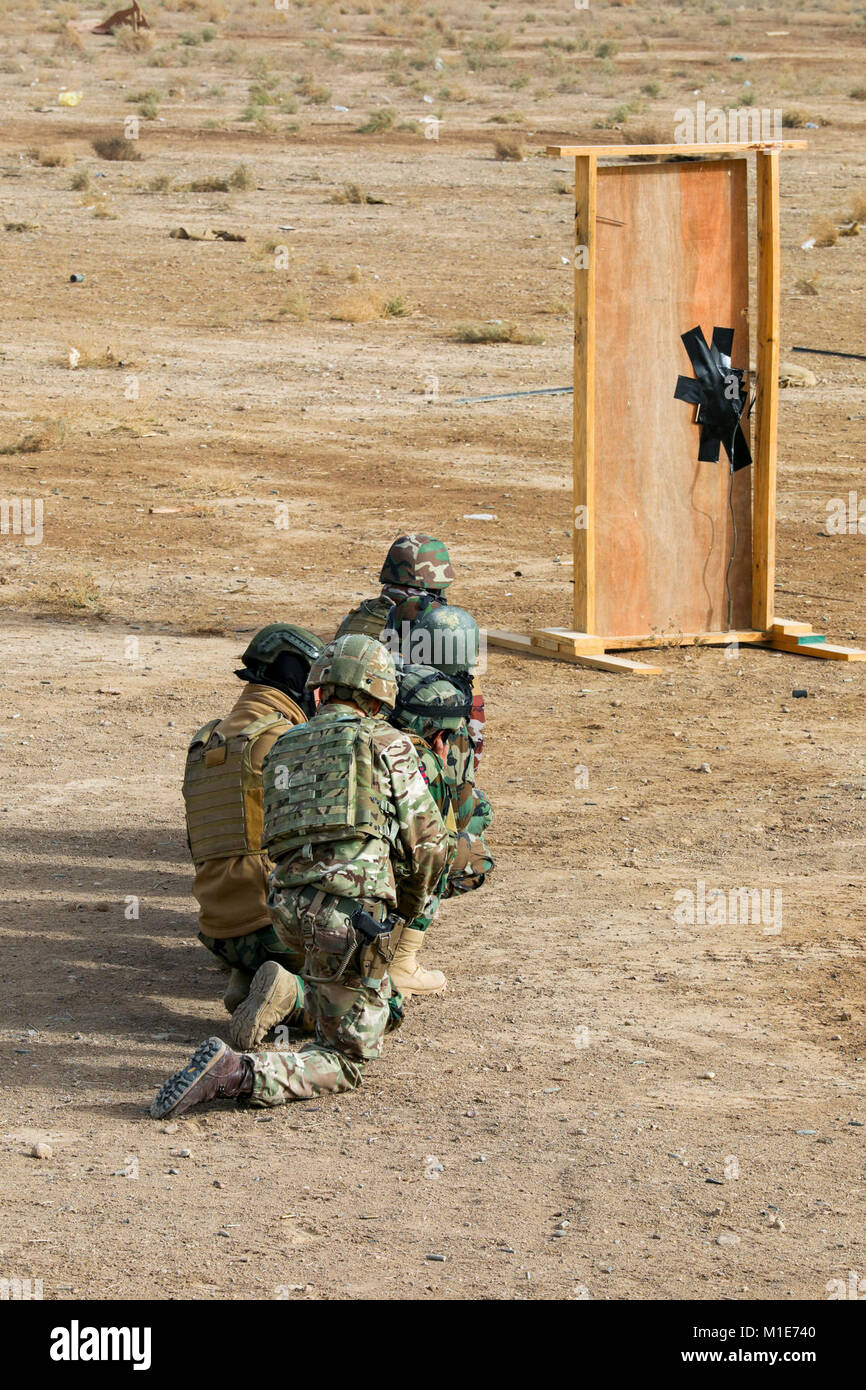 Iraqi security force members, with Qwat Khasa Battalion, crouch for ...
