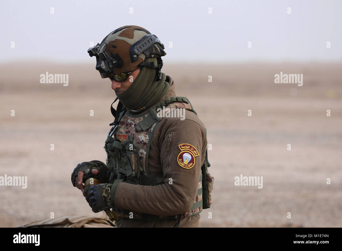 A Qwat Khasa member of the Iraqi army holds a 60mm mortar round in ...