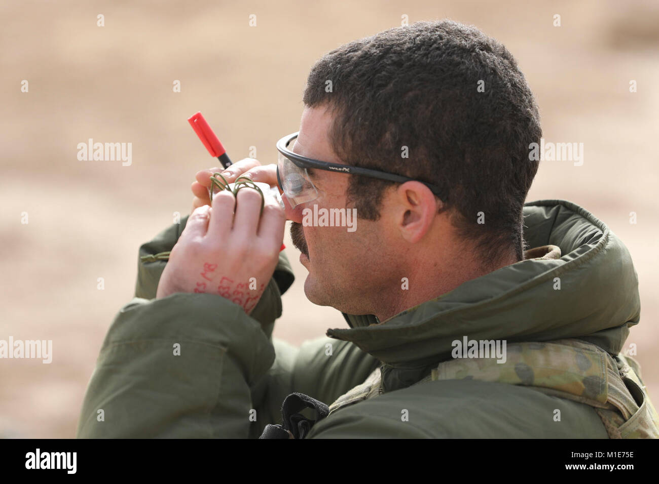 An Australian army trainer uses a compass to shoot an azimuth as part ...