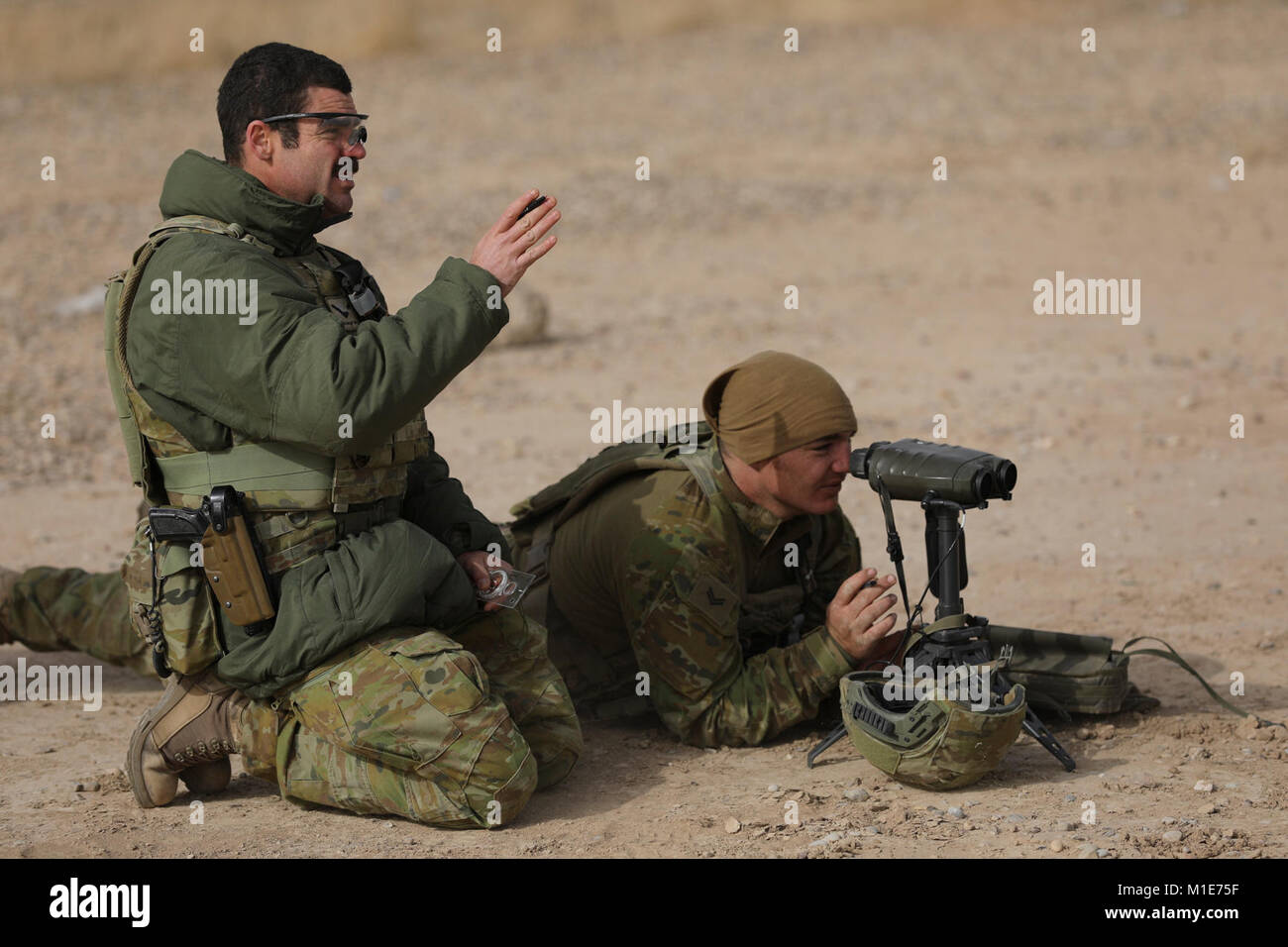Australian army trainers uses a compass and a set of binoculars as part ...