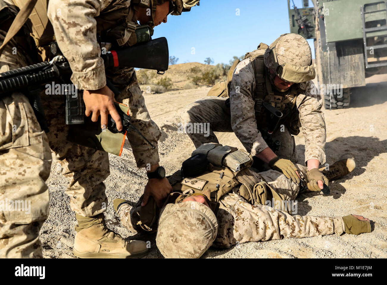 A Marine with Combat Logistics Battalion 3 applies a tourniquet to a simulated casualty during ...